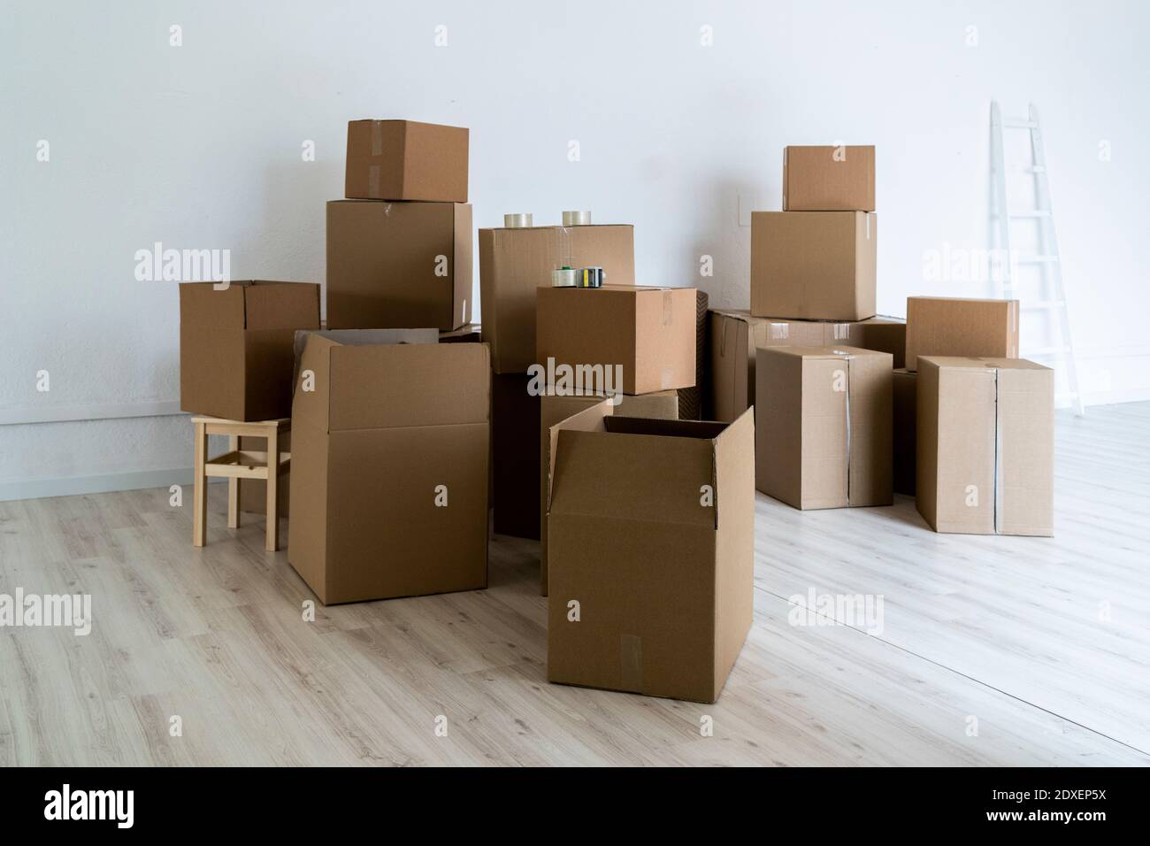 Cardboard boxes on floor in living room Stock Photo - Alamy