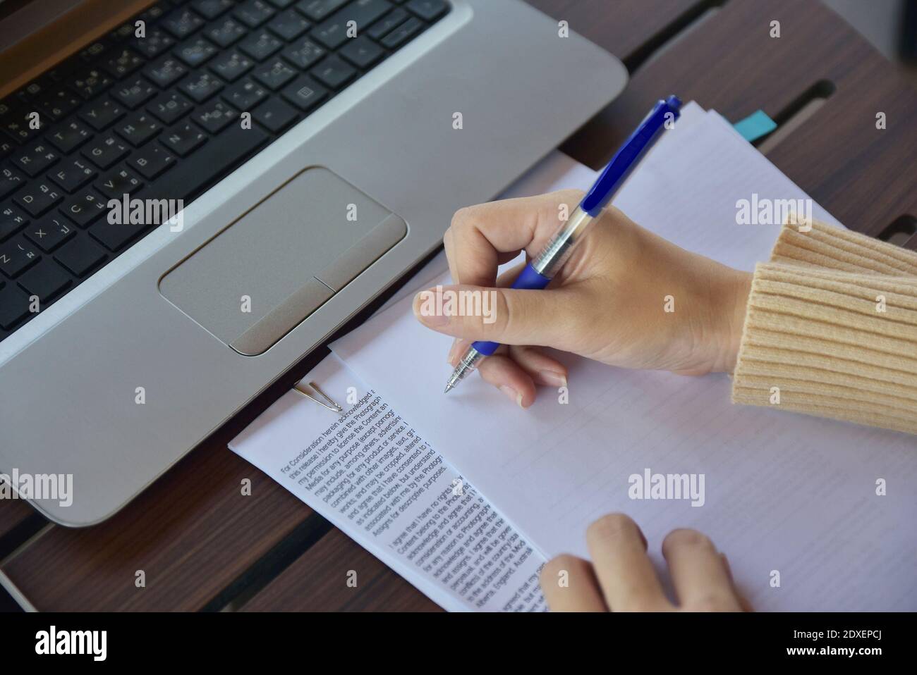 Businesswomen writing on document sitting work Stock Photo - Alamy