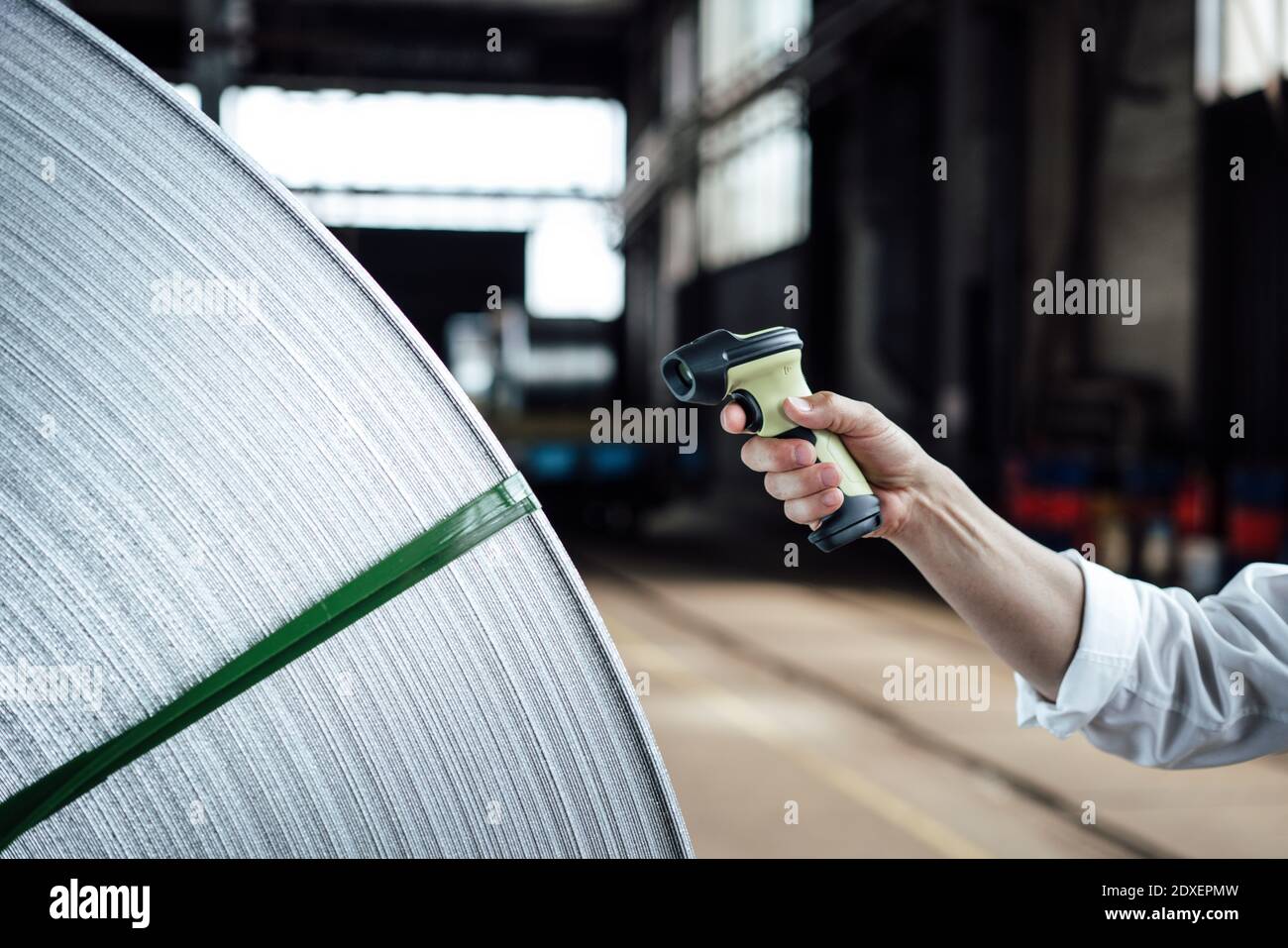 Man's hand scanning barcode on steel rolls in industry Stock Photo - Alamy