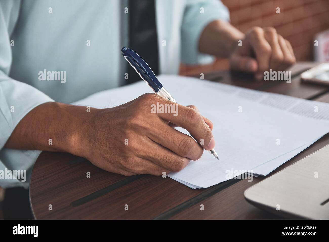 Businessman holding pen writing on paper document working,Close up hand ...