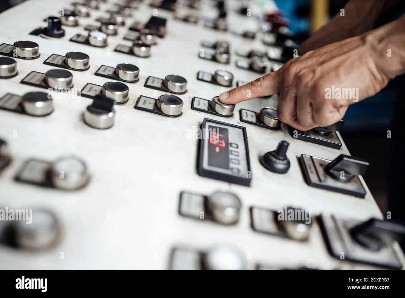 Man's hand operating control panel in factory Stock Photo - Alamy