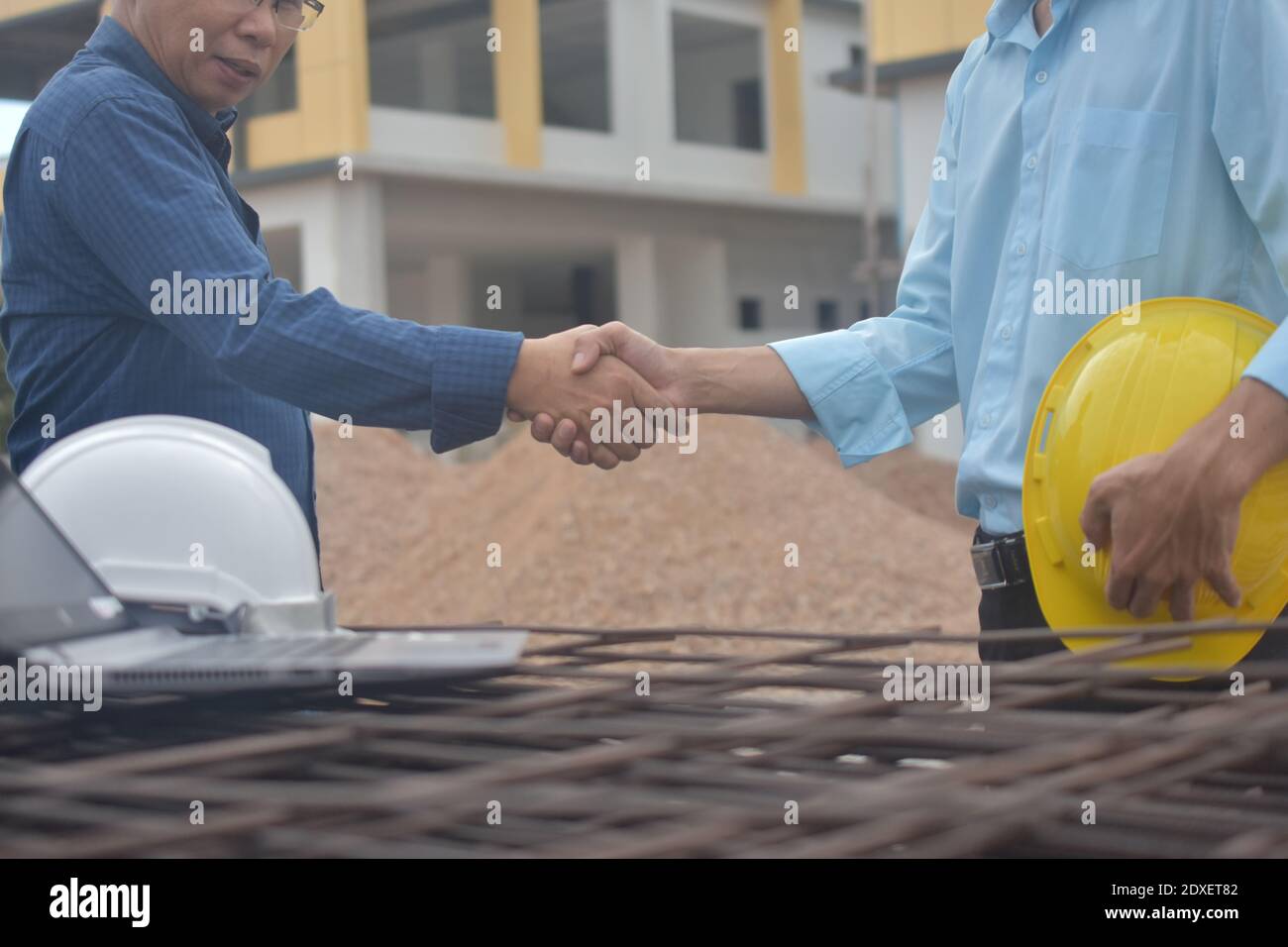Businessman Shaking hands is a business promise in project building ...