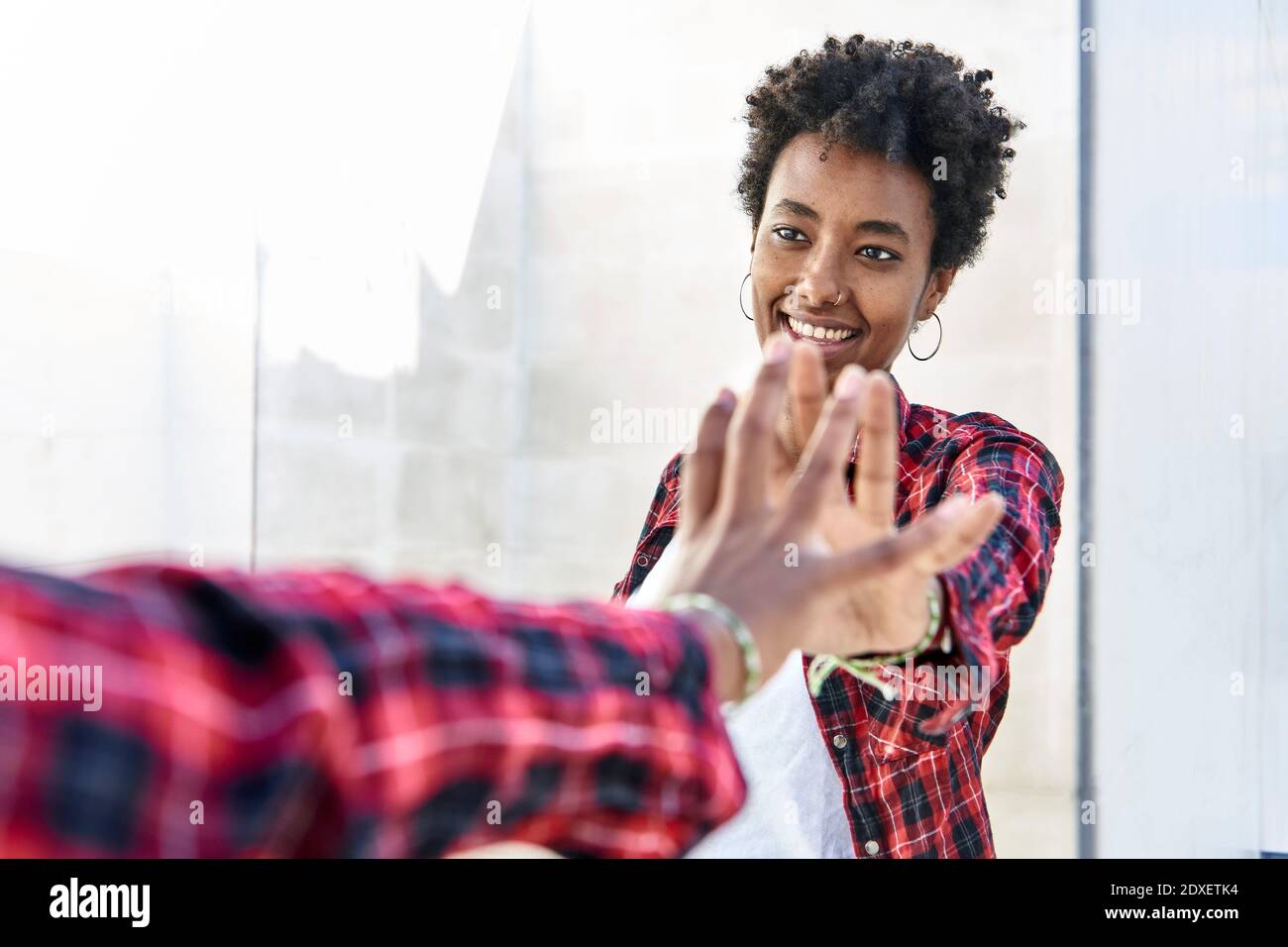 Smiling young Afro woman touching her mirror reflection Stock Photo - Alamy