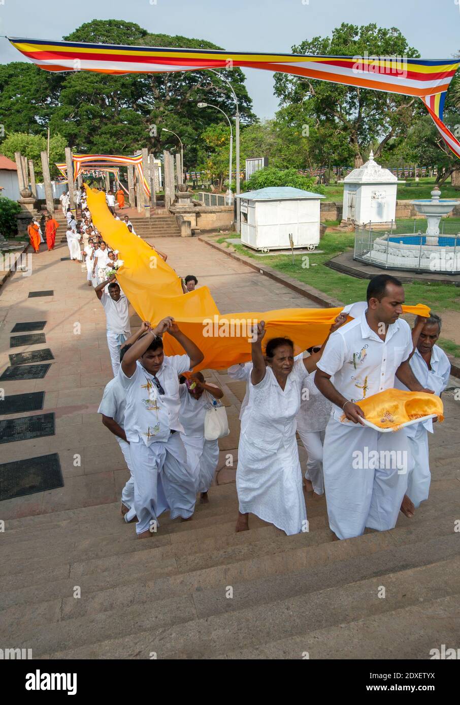 Buddhist worshippers on a pilgrimage to Anuradhapura in Sri Lanka carry ...
