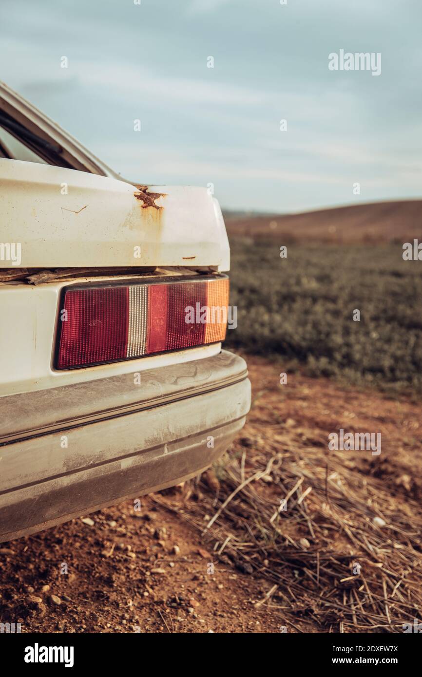 Back of abandoned car deteriorating outdoors Stock Photo - Alamy