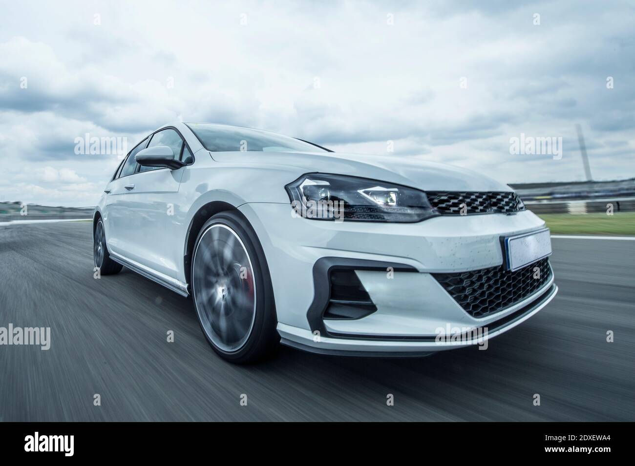 White sports car racing on asphalt track Stock Photo - Alamy