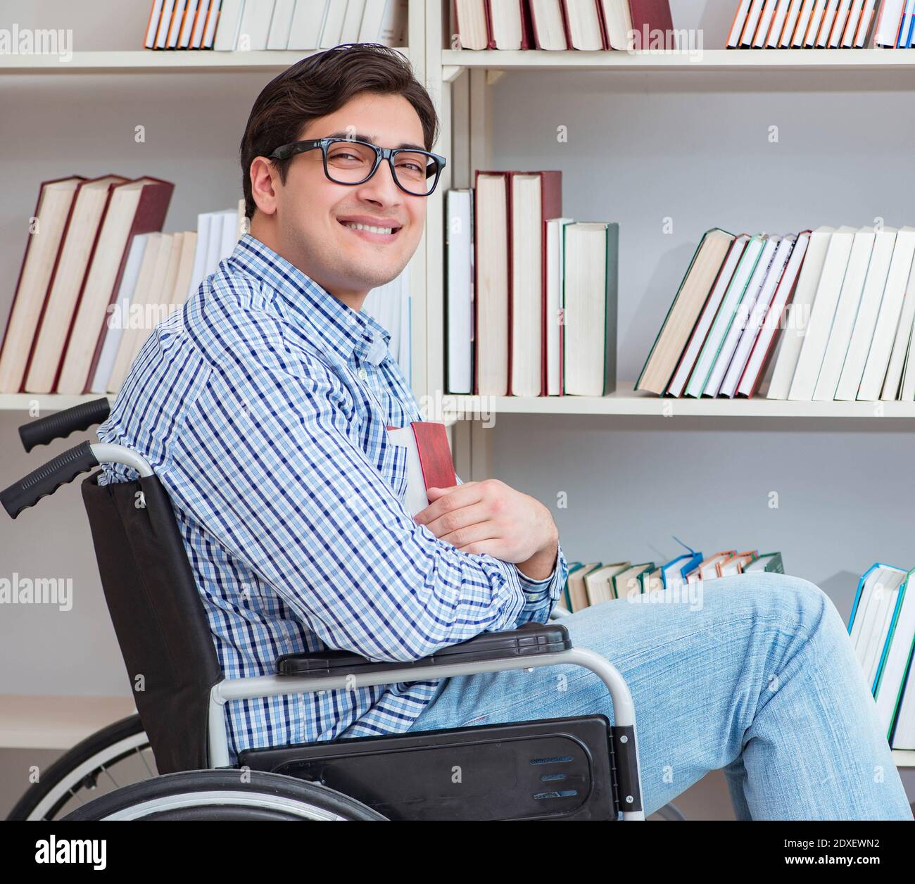 The disabled student studying in the library Stock Photo - Alamy