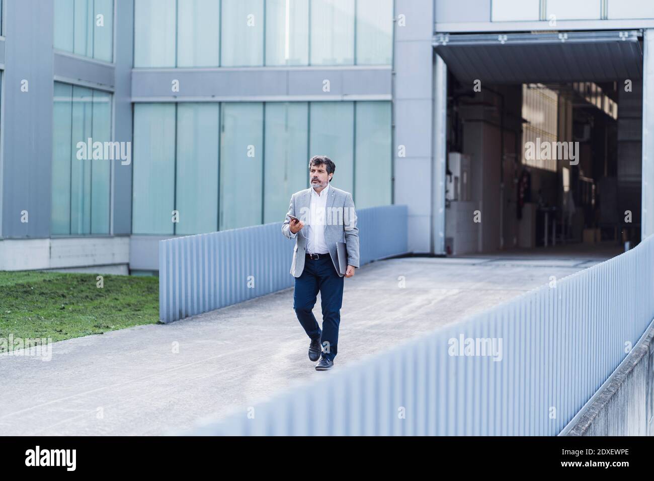 Professional man walking laptop computer hi-res stock photography and ...