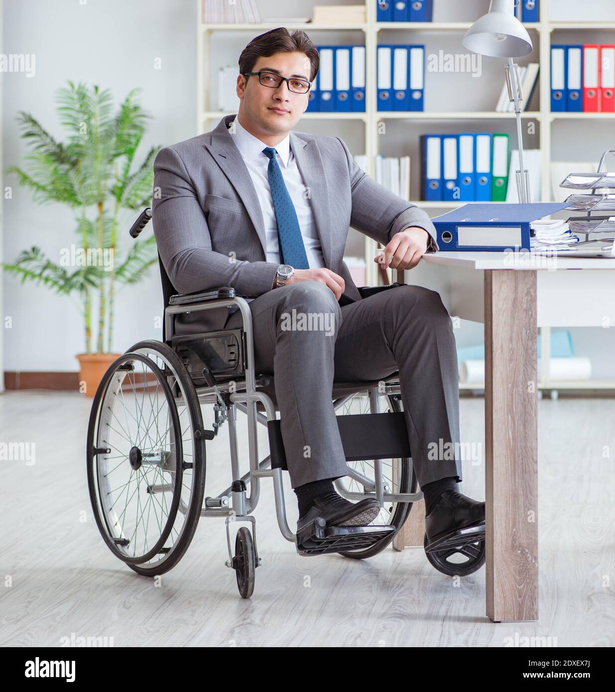 The disabled businessman working in the office Stock Photo - Alamy