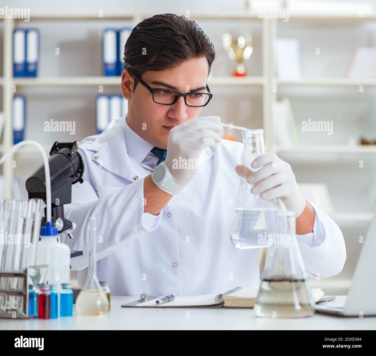 Young researcher scientist doing a water test contamination experiment ...