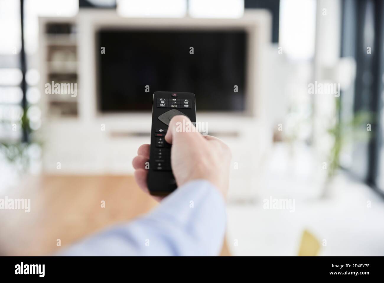 Man using remote control at home Stock Photo - Alamy