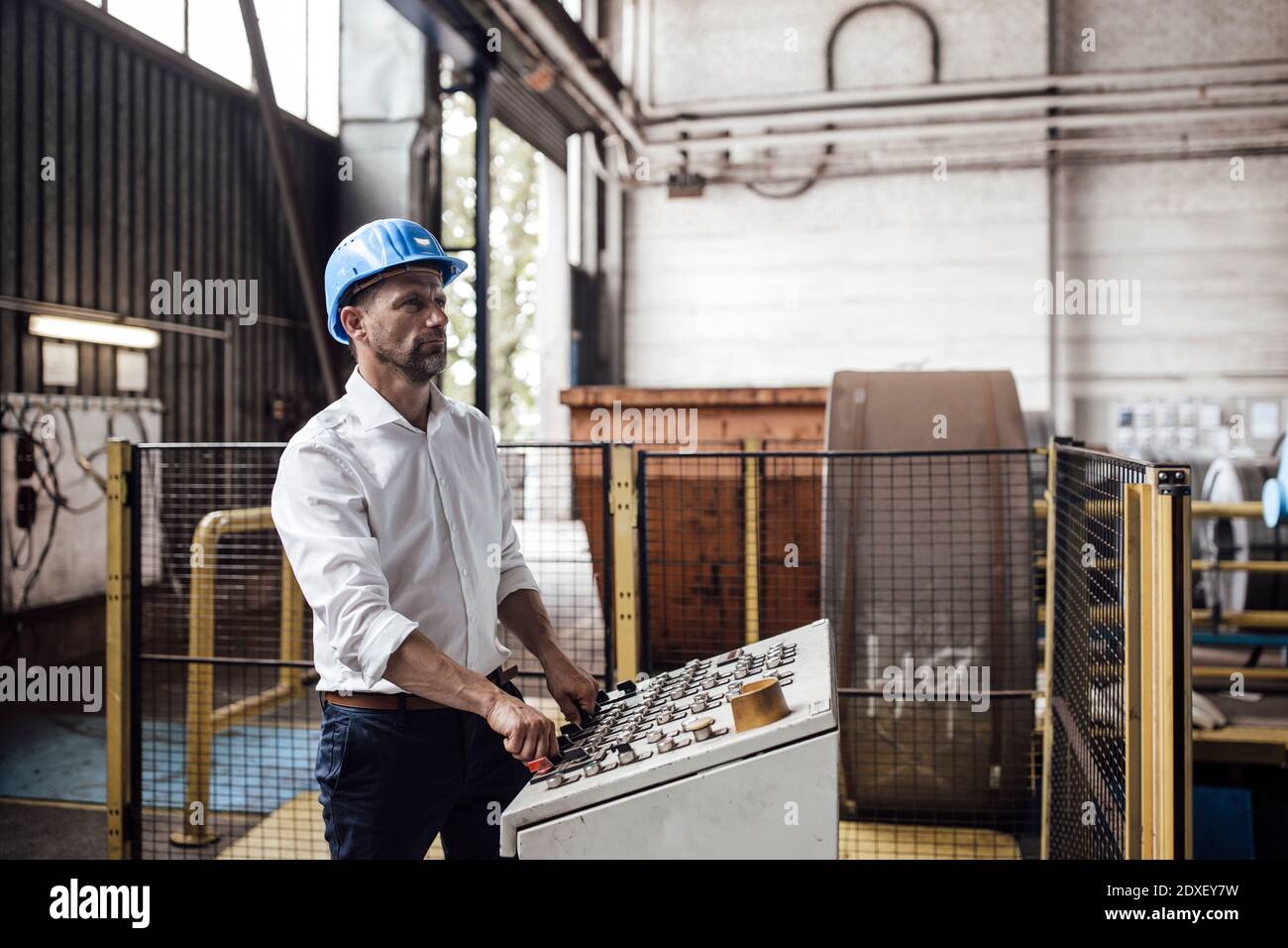 Businessman operating control panel at factory Stock Photo - Alamy