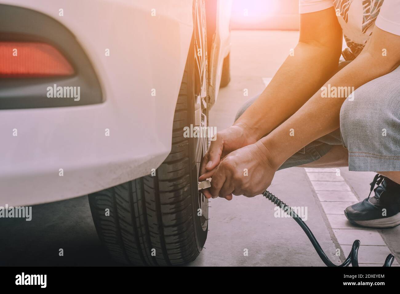 People inflating the tires of car parked Stock Photo - Alamy