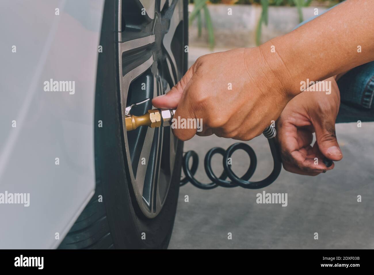 People inflating the tires of car parked Stock Photo - Alamy