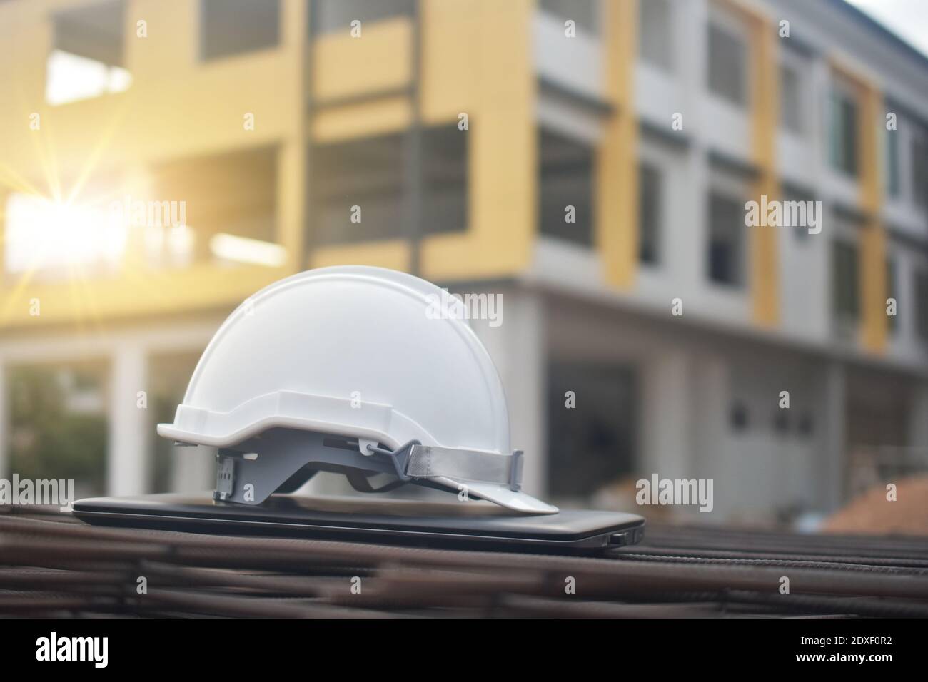 Hard hat safety on computer notebook building construction estate ...