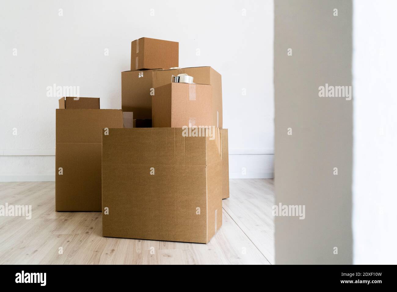Brown cardboard boxes against wall in living room of new house Stock ...