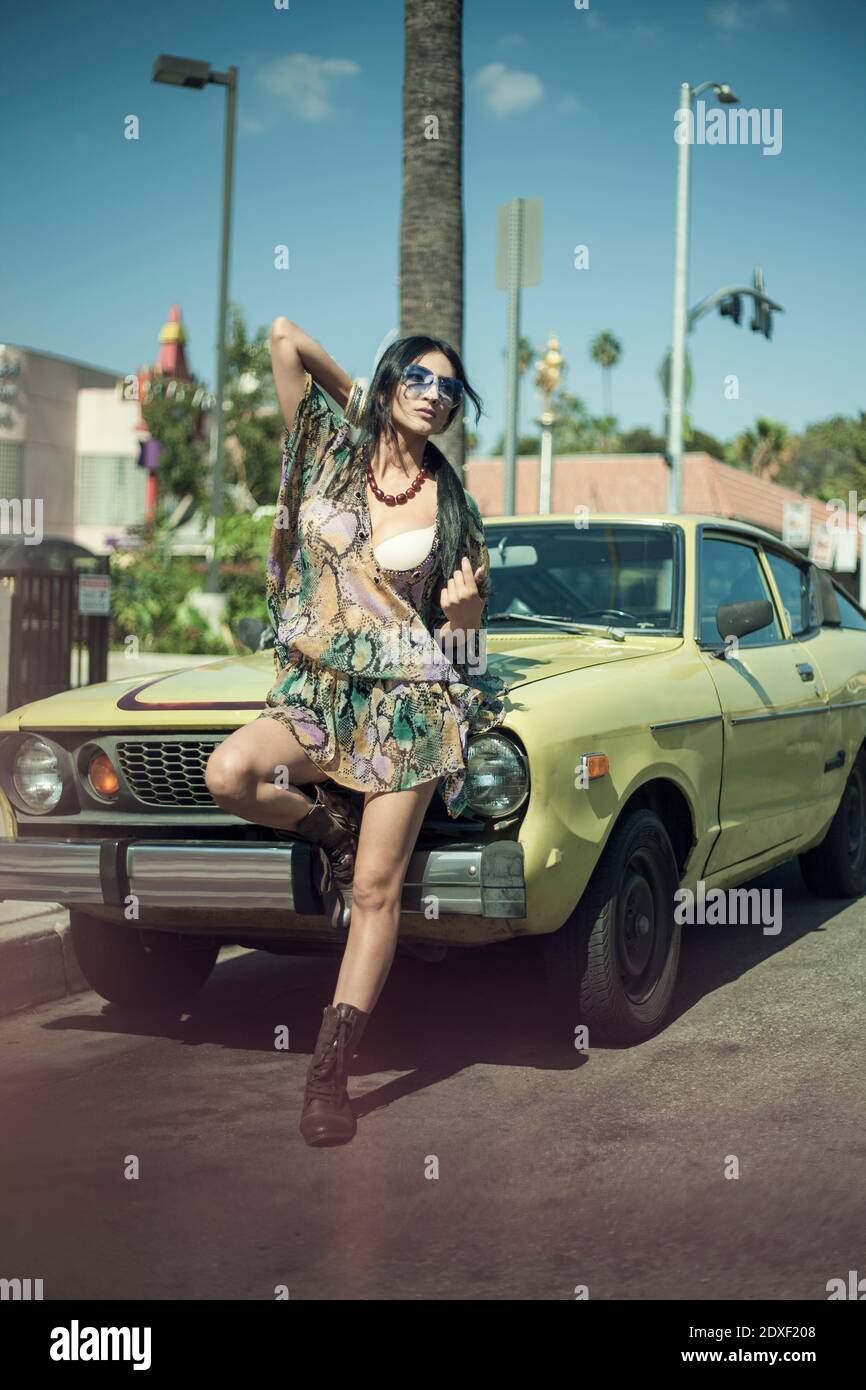 Beautiful woman standing by car on street Stock Photo - Alamy