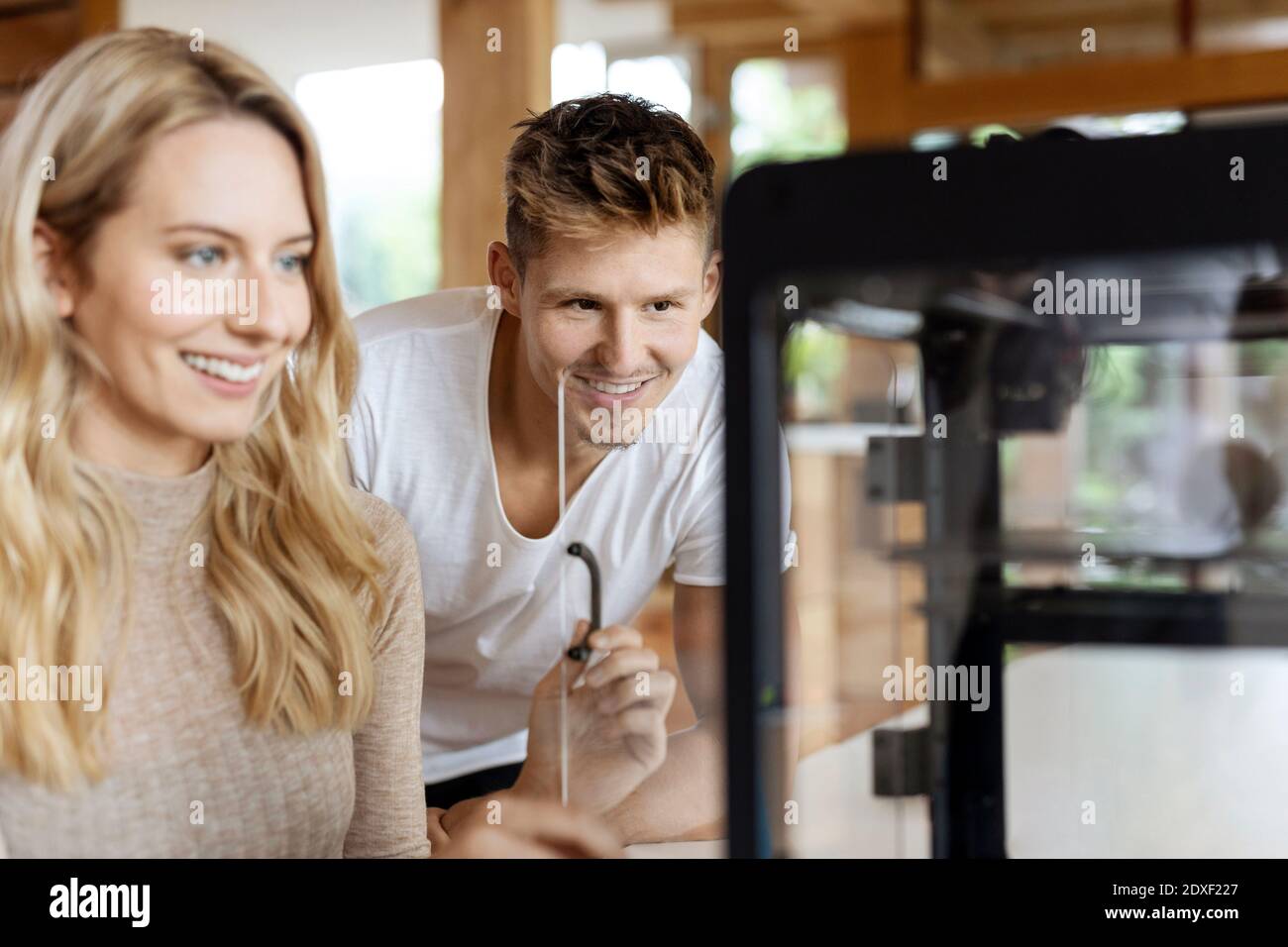 Business people looking at 3D printer while sitting at home Stock Photo ...