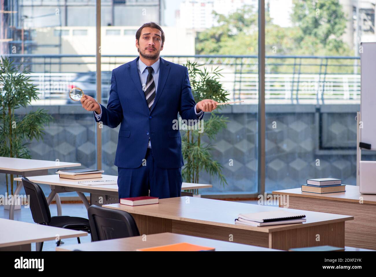 Young teacher in suit in the classroom Stock Photo - Alamy