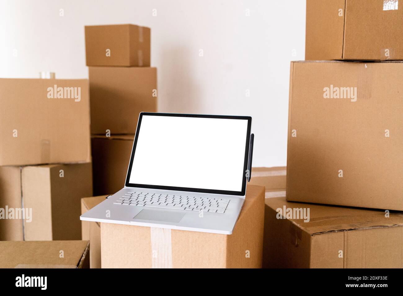 Laptop on cardboard box in living room of new house Stock Photo - Alamy