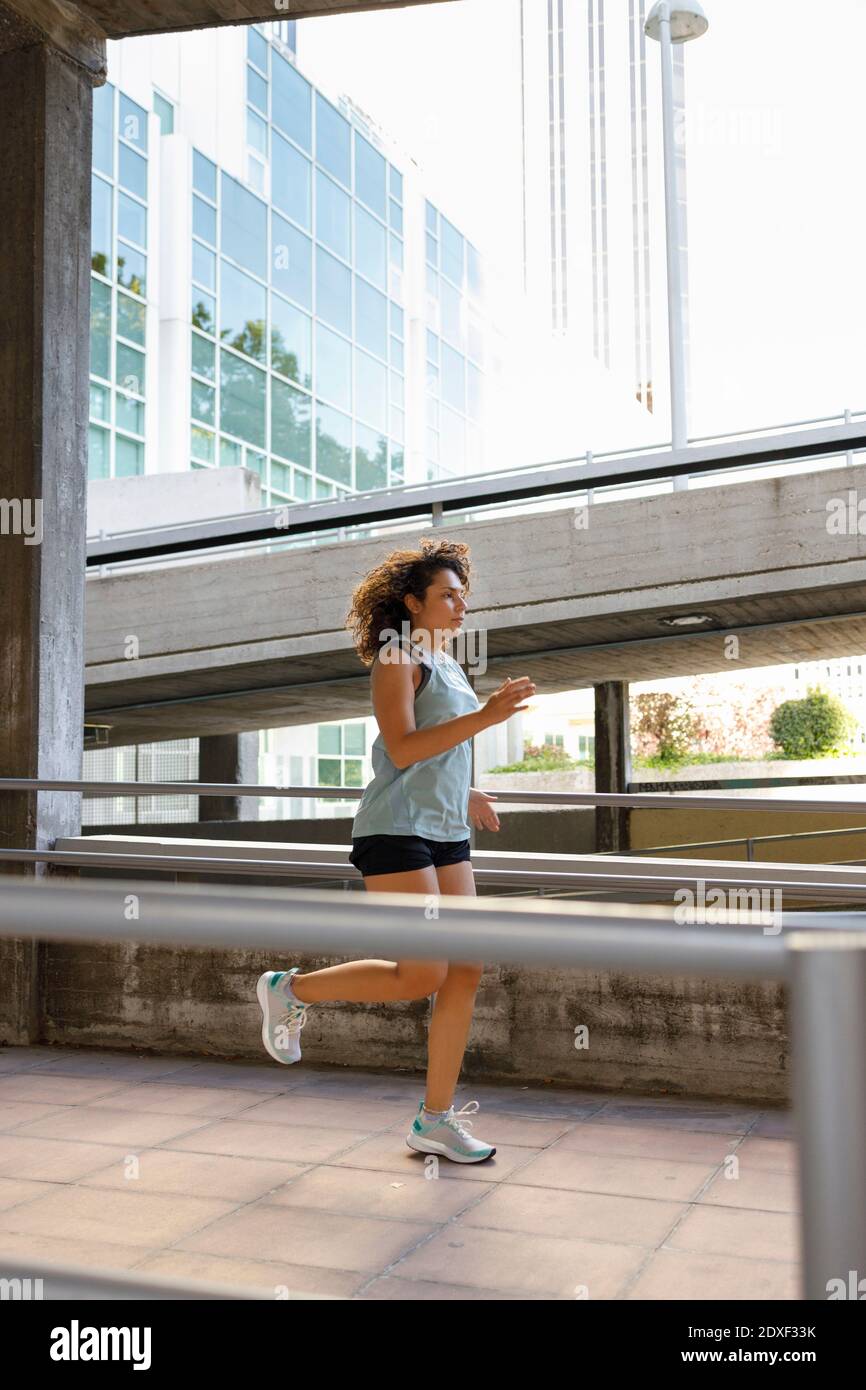 Young athlete running exercising while running on bridge Stock Photo ...