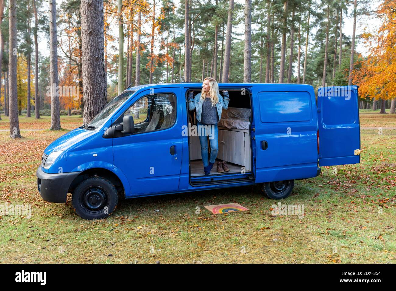 Mid adult woman leaning out on door of van at Cannock Chase Stock Photo ...