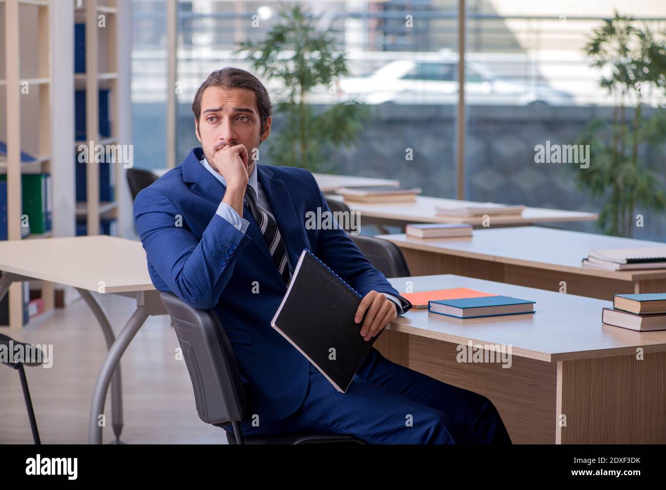 Young teacher in suit in the classroom Stock Photo - Alamy
