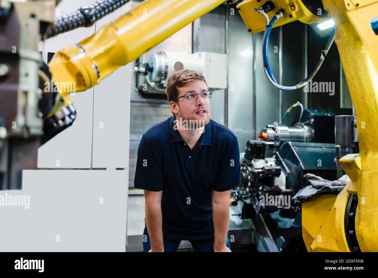 Male factory worker examining in industry Stock Photo - Alamy
