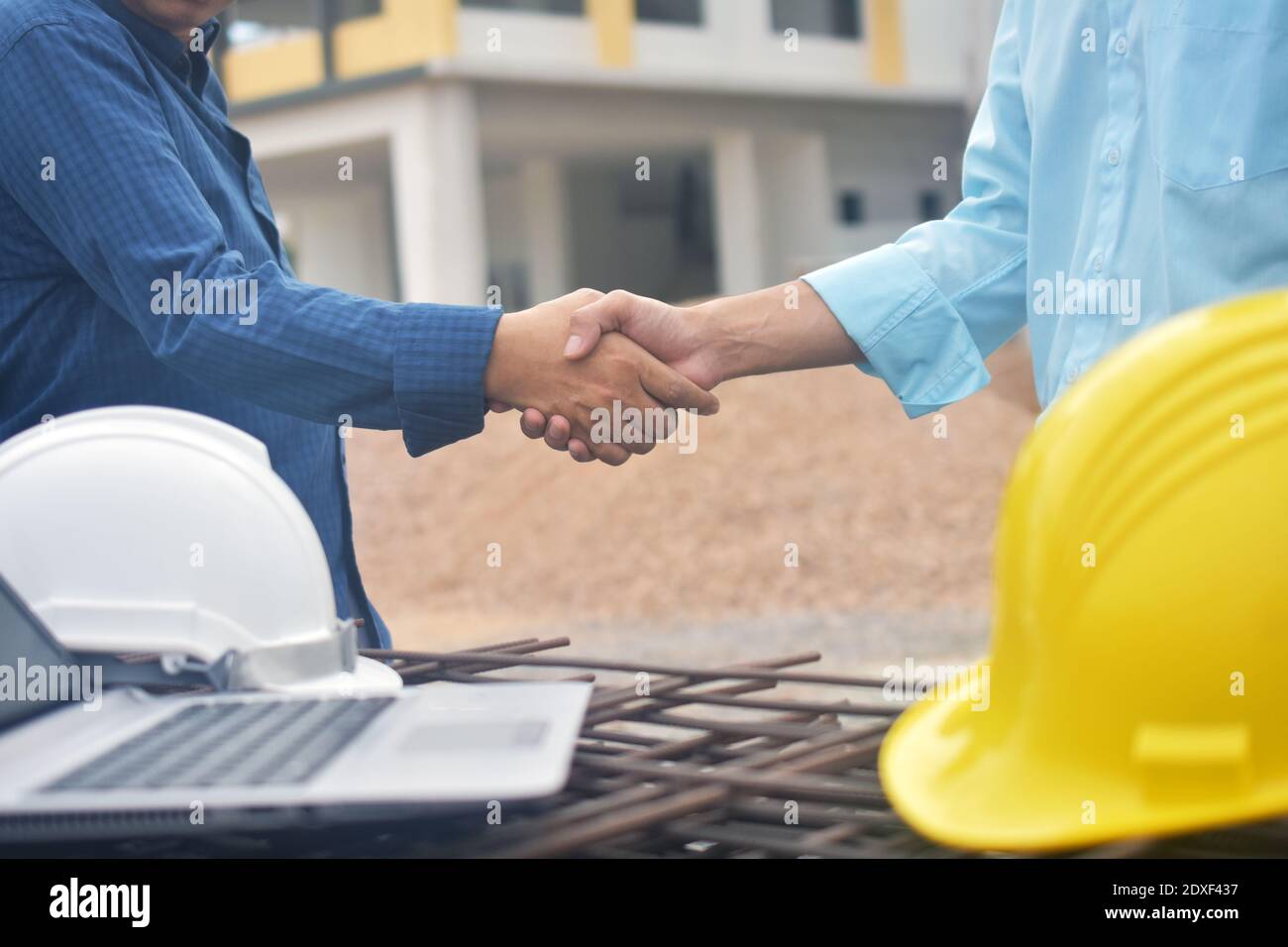 Engineering hands shake at work place building construction estate ...