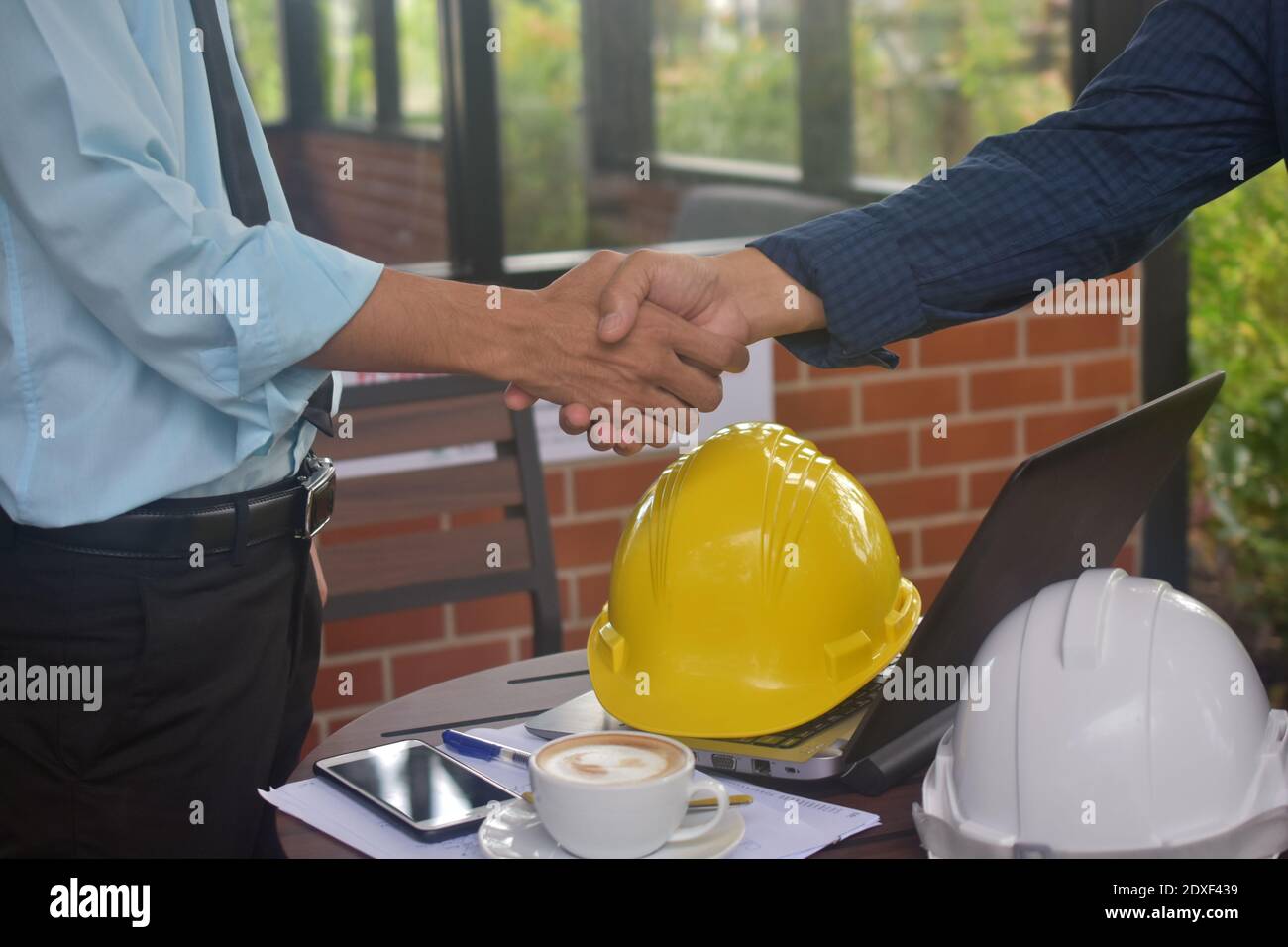 Engineering hands shake at work place building construction estate ...