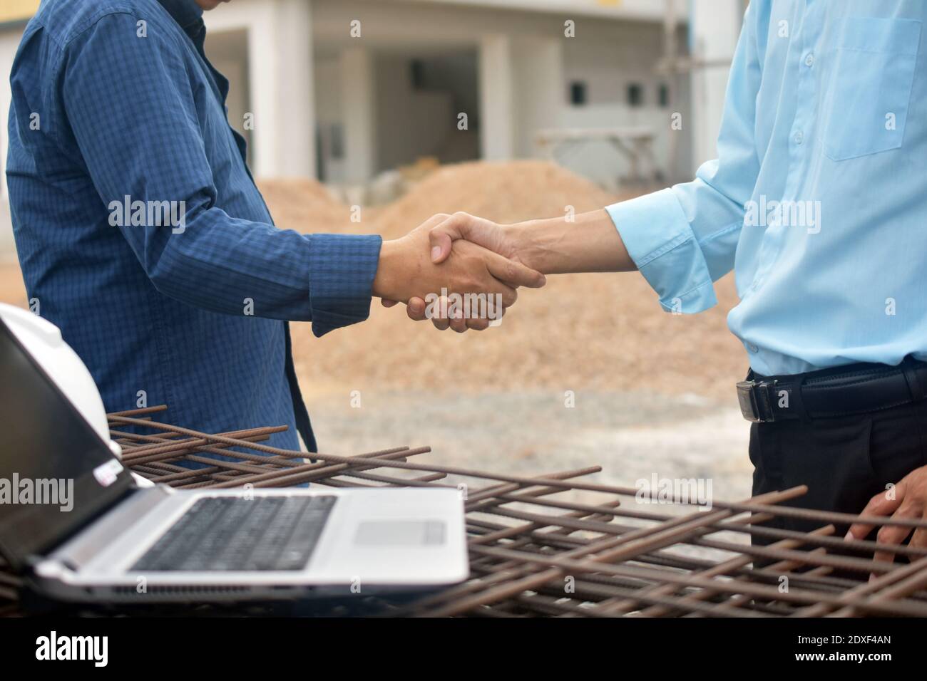 Engineering hands shake at work place building construction estate ...