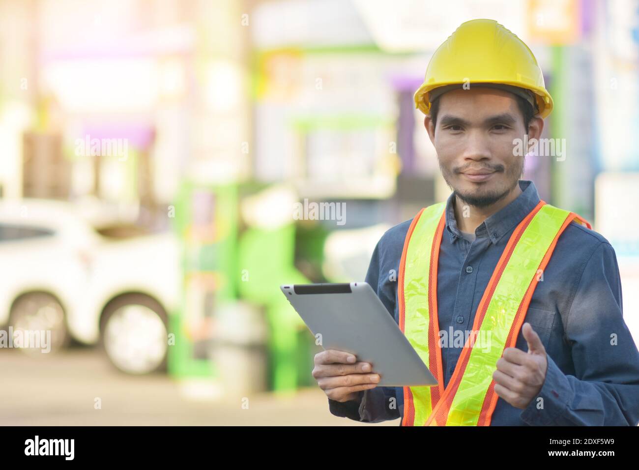 Engineering holding tablet and Hand success concept Oil station power ...