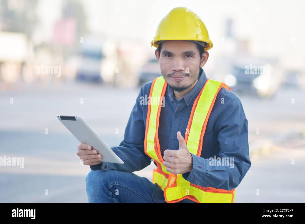 Engineering Holding tablet Highway transportation on road background ...