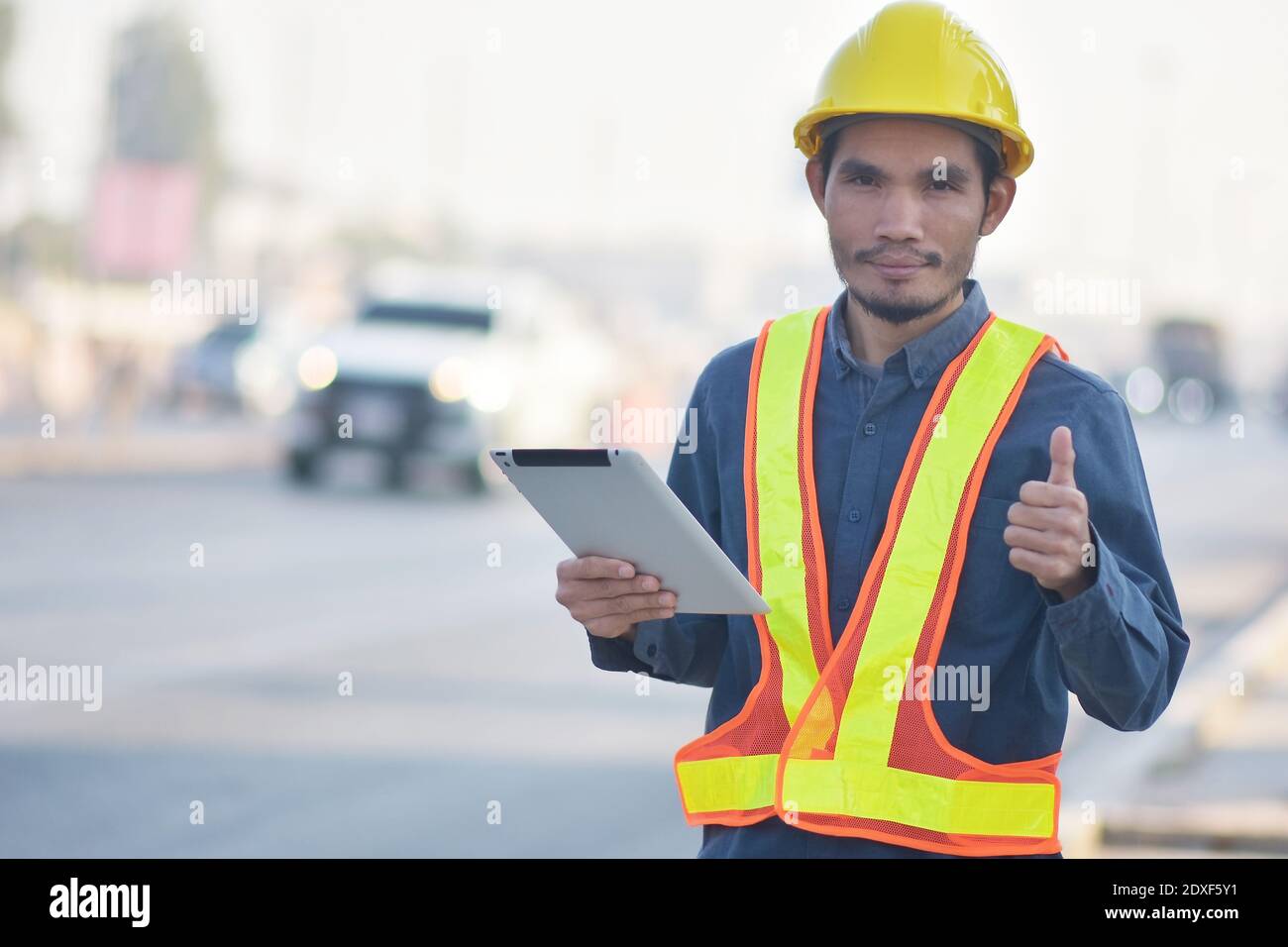 Engineering Holding tablet Highway transportation on road background ...