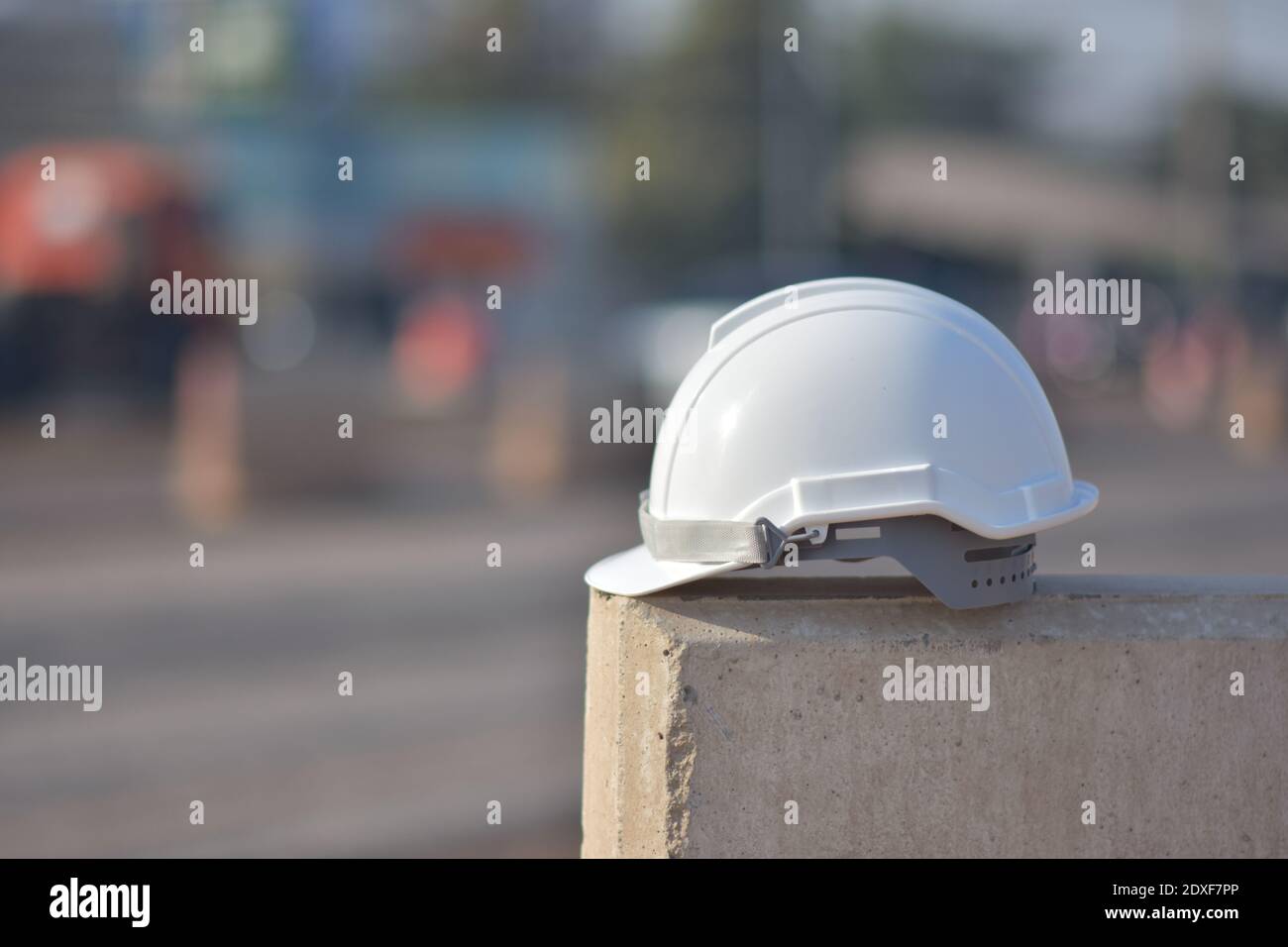 White helmet on barrier Engineering road construction Stock Photo - Alamy
