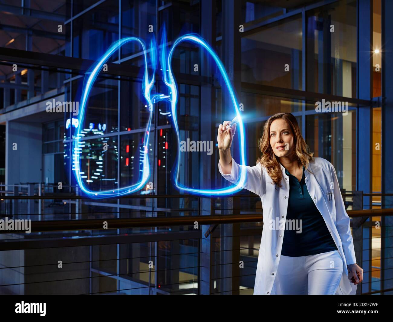 Female pulmonologist light painting lung in laboratory at hospital ...