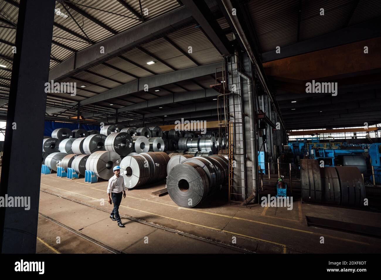 Male owner walking in industry Stock Photo - Alamy