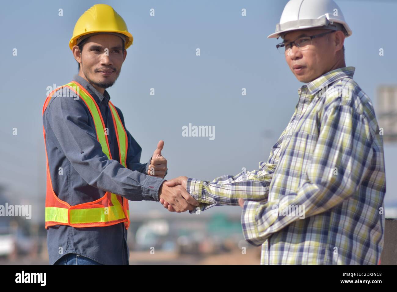 Engineering hands shake at work place building construction estate ...