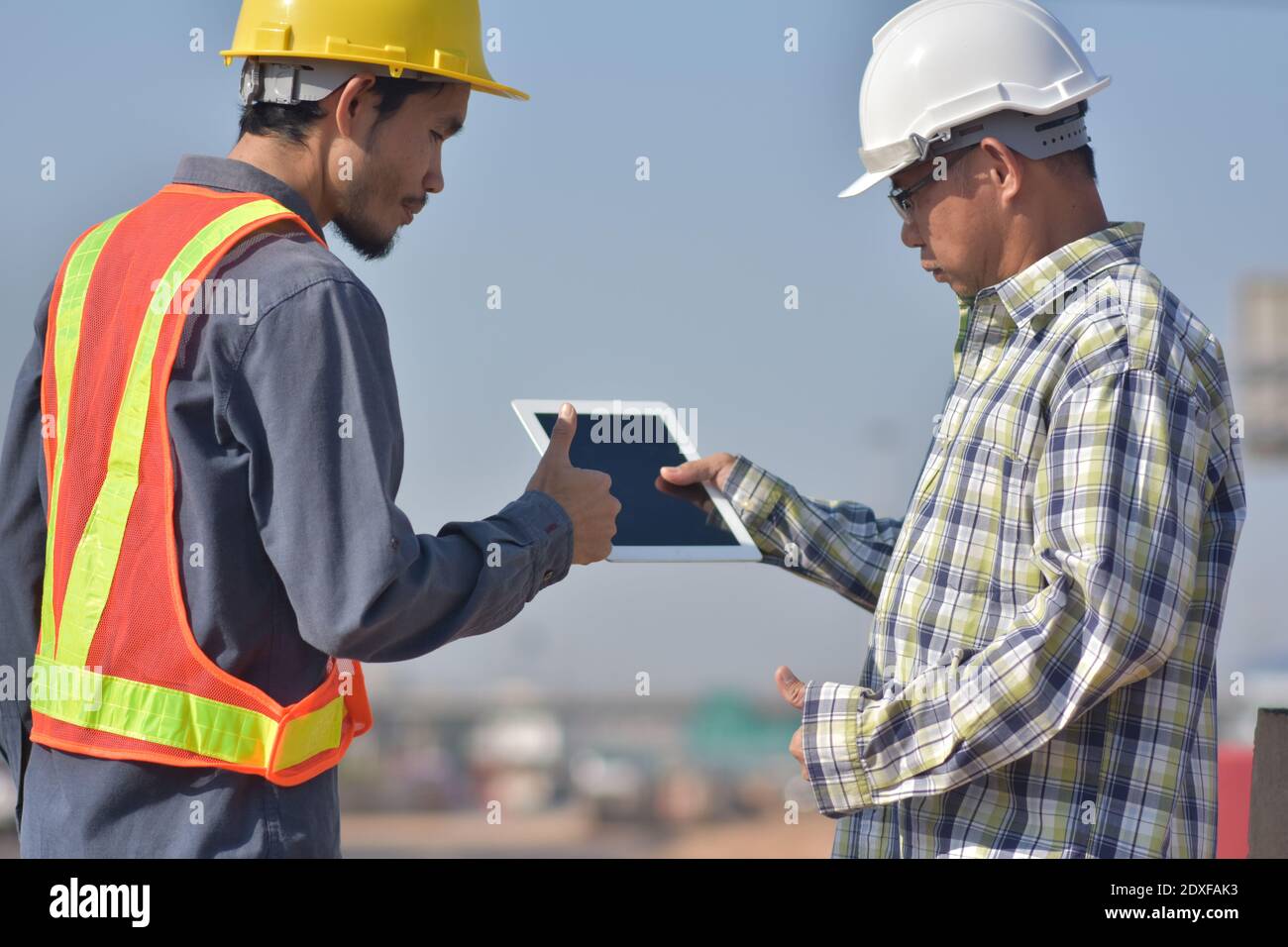 Two Engineering using tablet technology checking inspection work ...