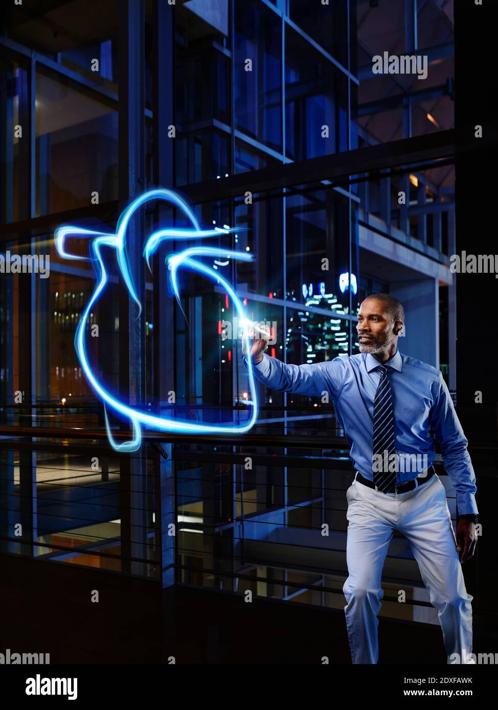 Male cardiologist light painting heart in laboratory at hospital Stock ...