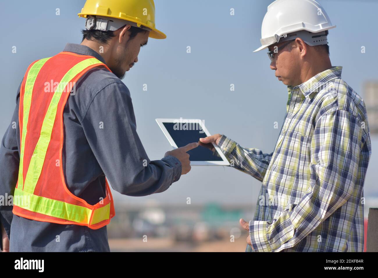 Construction Engineering holding tablet and choice tools equipment ...