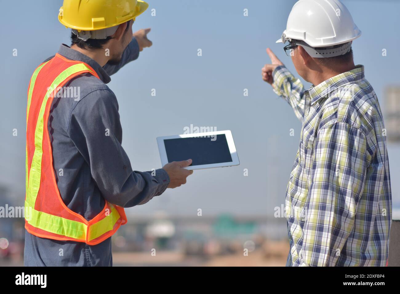 Two Engineering use tablet working road construction talking project ...