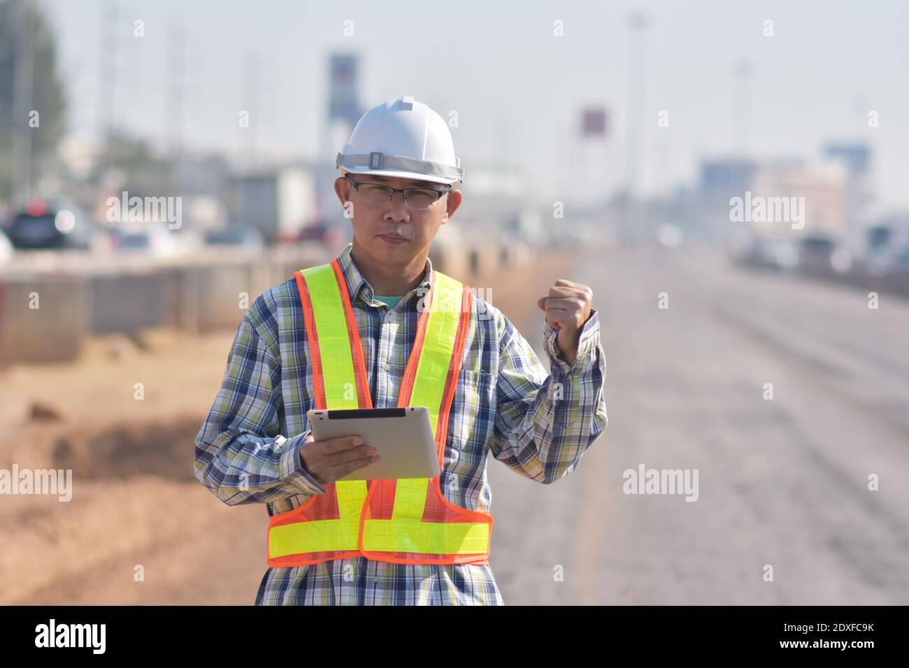 Senior Engineering worker by tablet inspection on site road ...