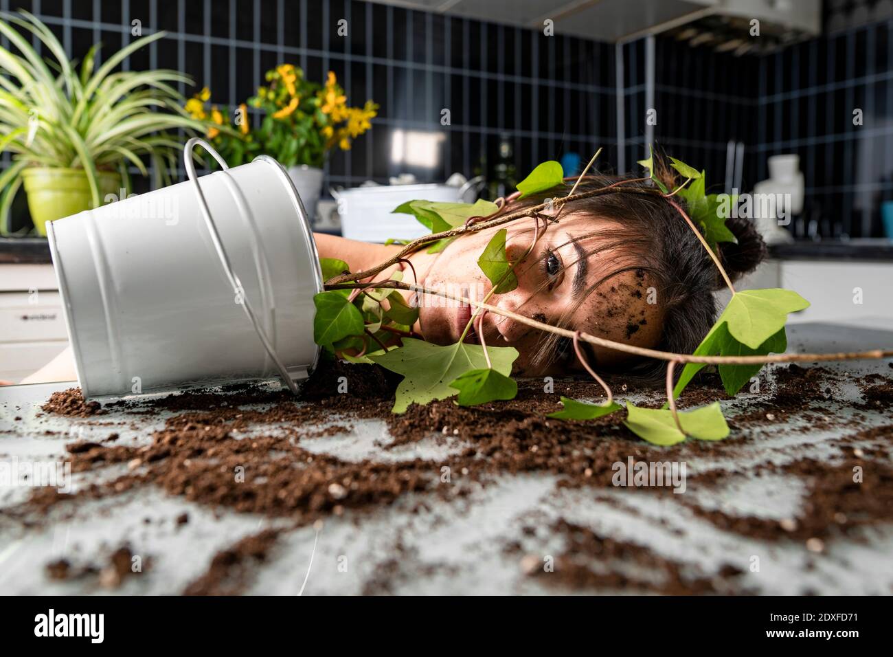 Sad woman leaning on messy table at home Stock Photo - Alamy