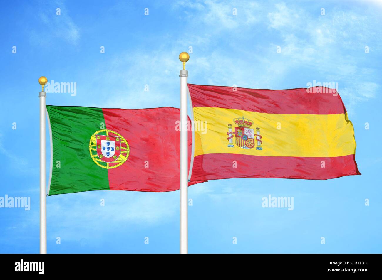 Portugal and Spain two flags on flagpoles and blue sky Stock Photo - Alamy