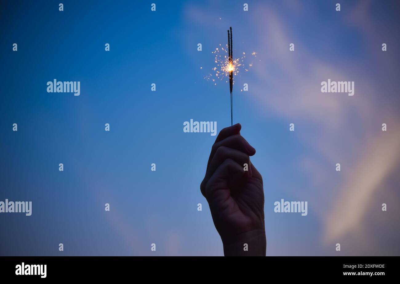 Hand holding firework on Sky evening celebration Merry Christmas and ...