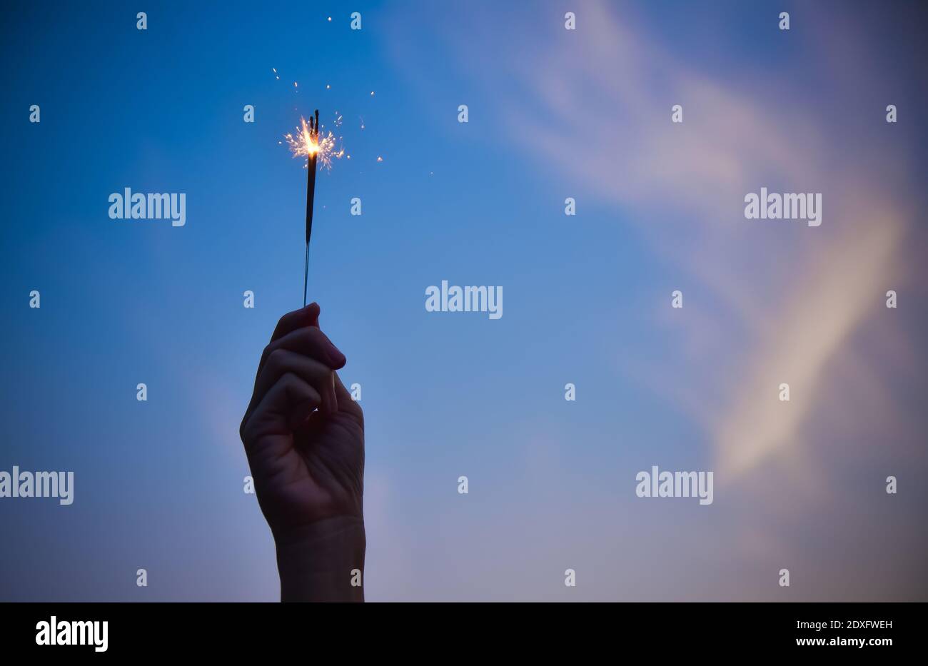 Hand holding firework on Sky evening celebration Merry Christmas and ...