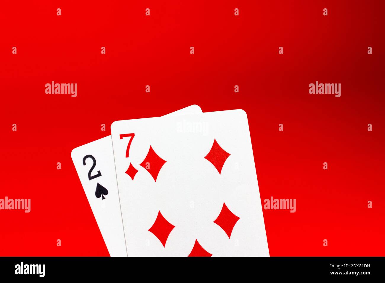 Weak poker hand. Playing cards on a red background. Losing, bad luck ...