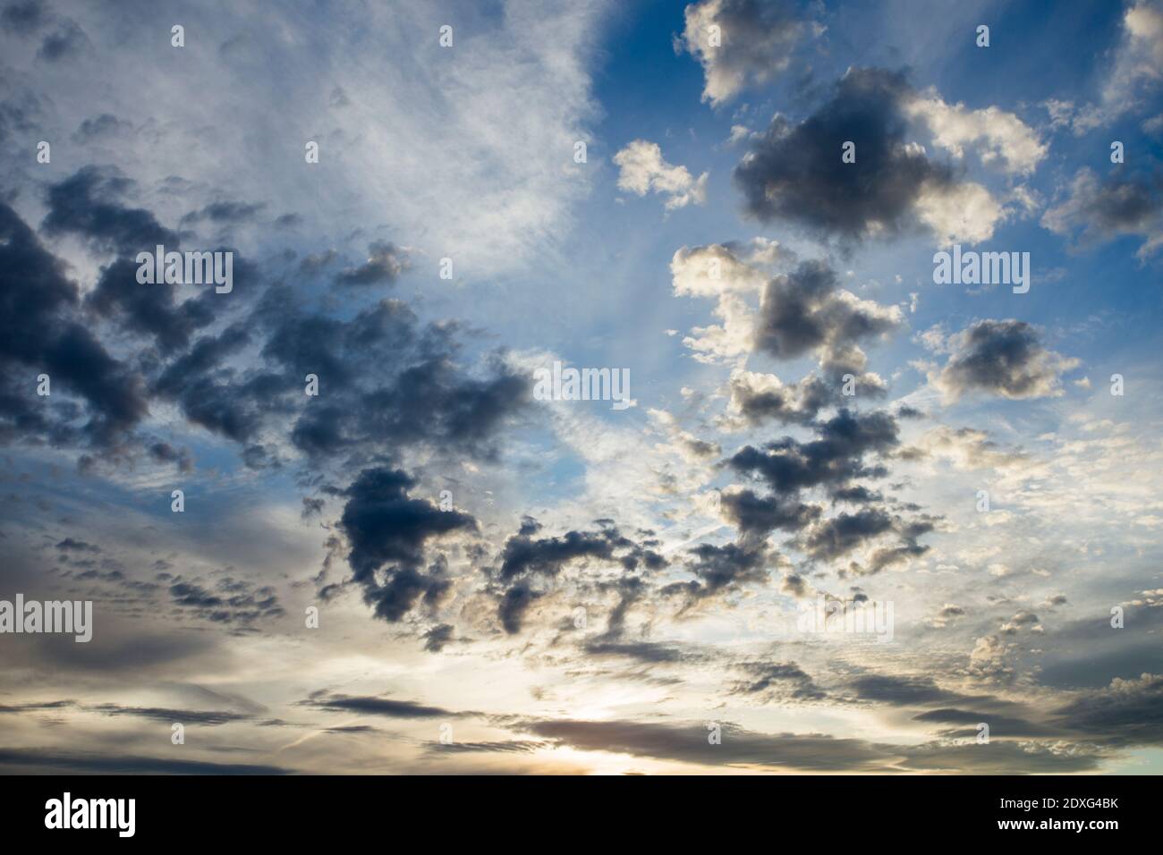 A Cumulus sunset clouds with sun setting down Stock Photo - Alamy