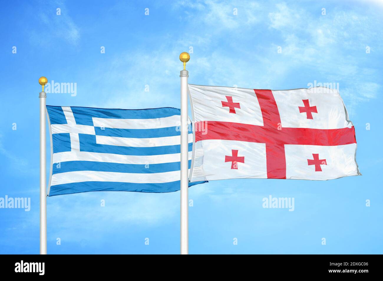 Greece and Georgia two flags on flagpoles and blue sky Stock Photo - Alamy
